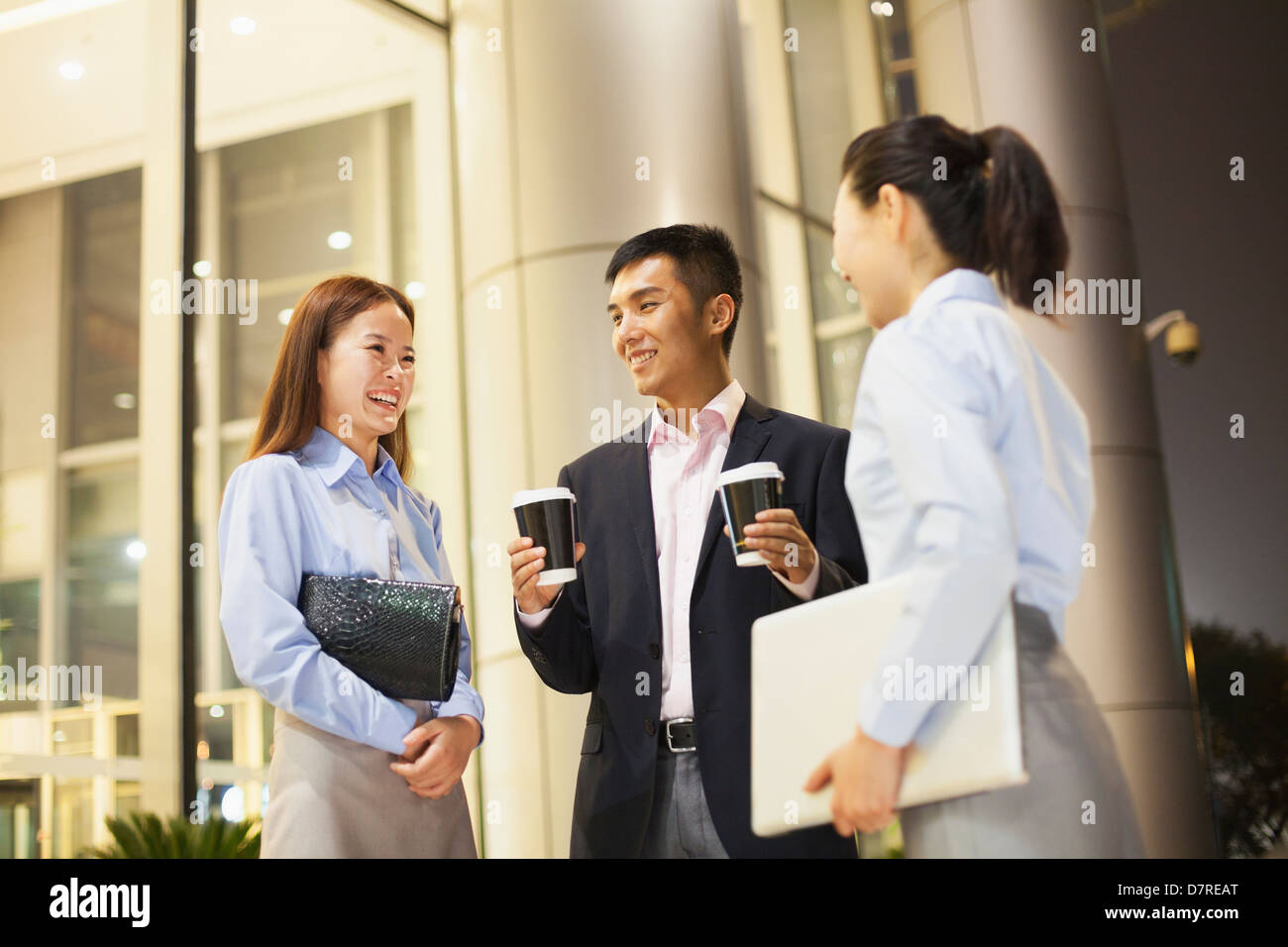 three business people talking outside the office Stock Photo - Alamy