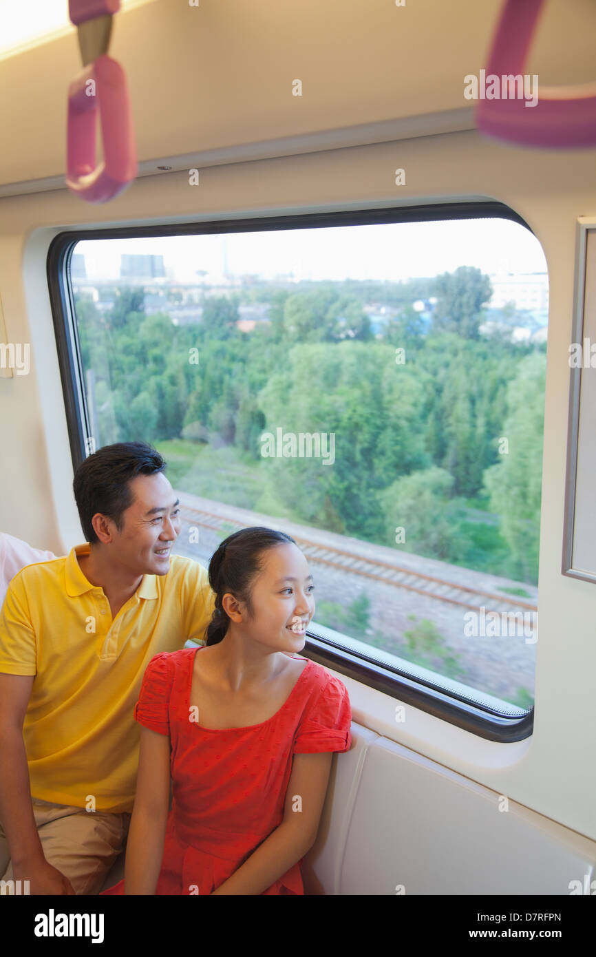 Father and daughter looking through the window in the subway Stock ...