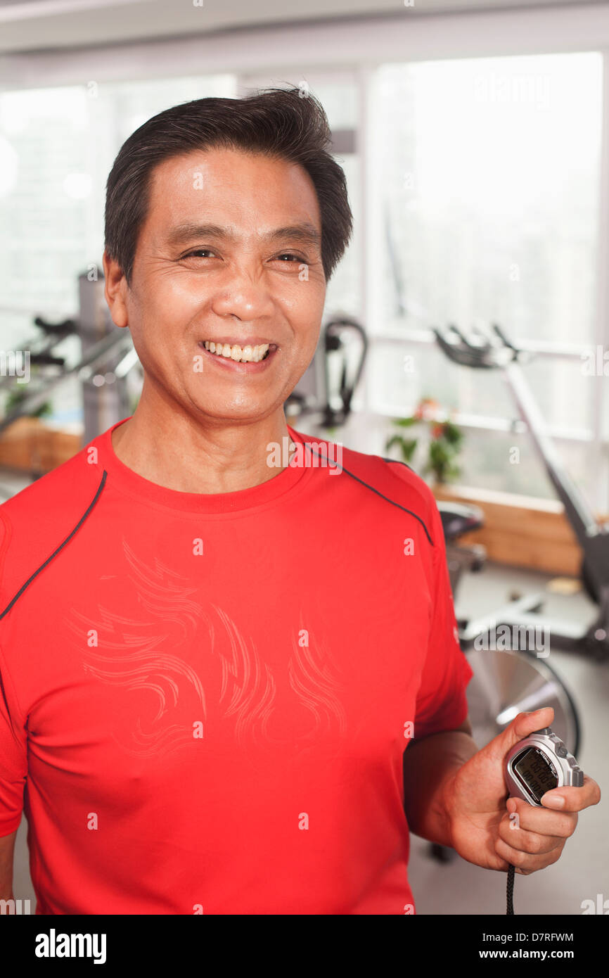Man with stopwatch in the gym Stock Photo - Alamy