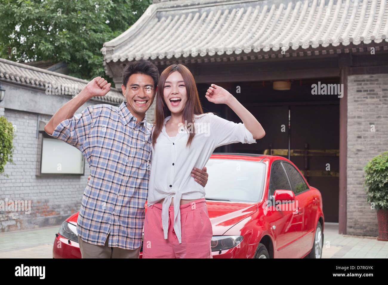 Young Couple in Front of Their Car Stock Photo - Alamy