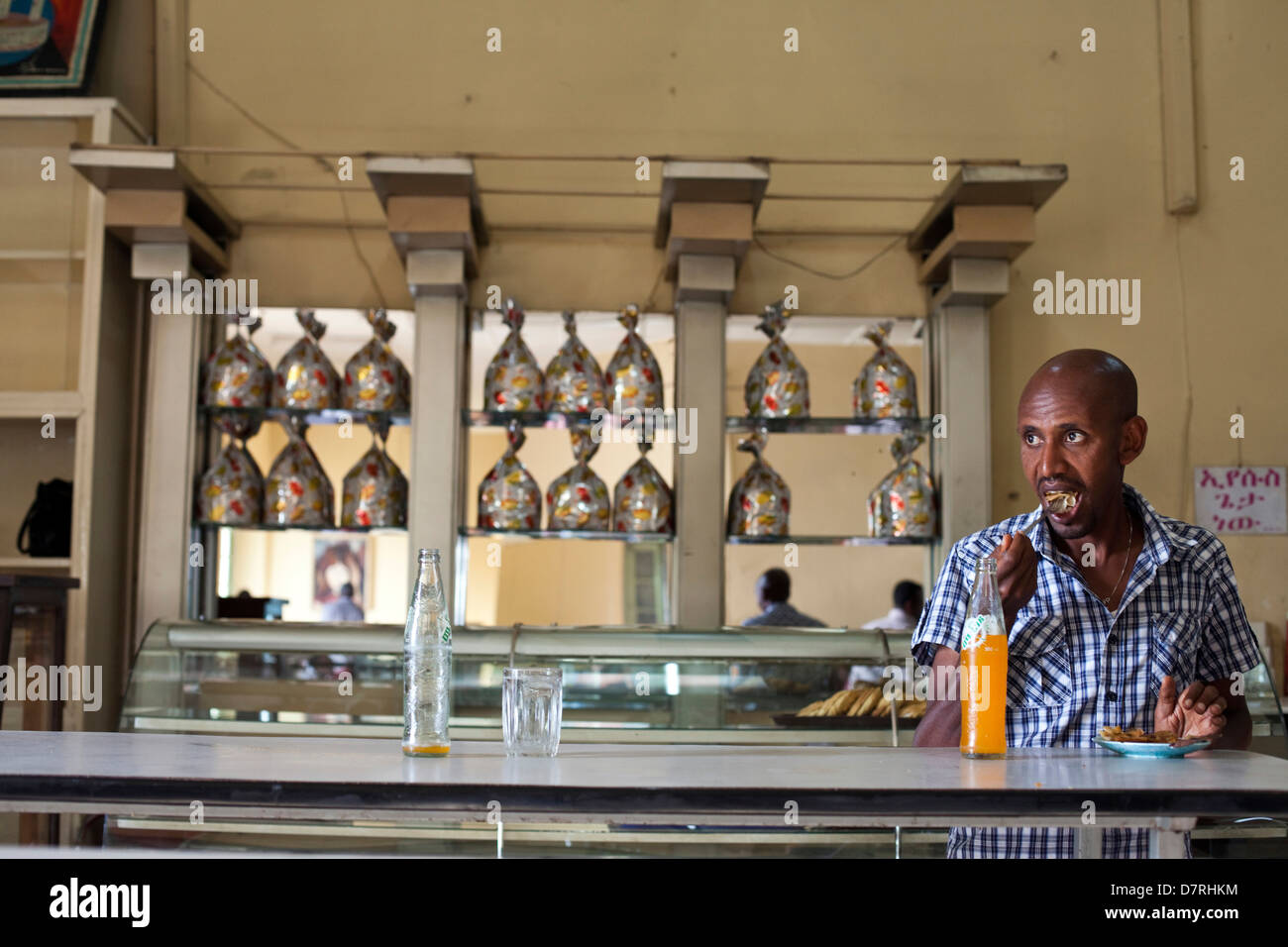 A customer eats baklava in the Ras Makonnen coffee house in Addis Ababa ...