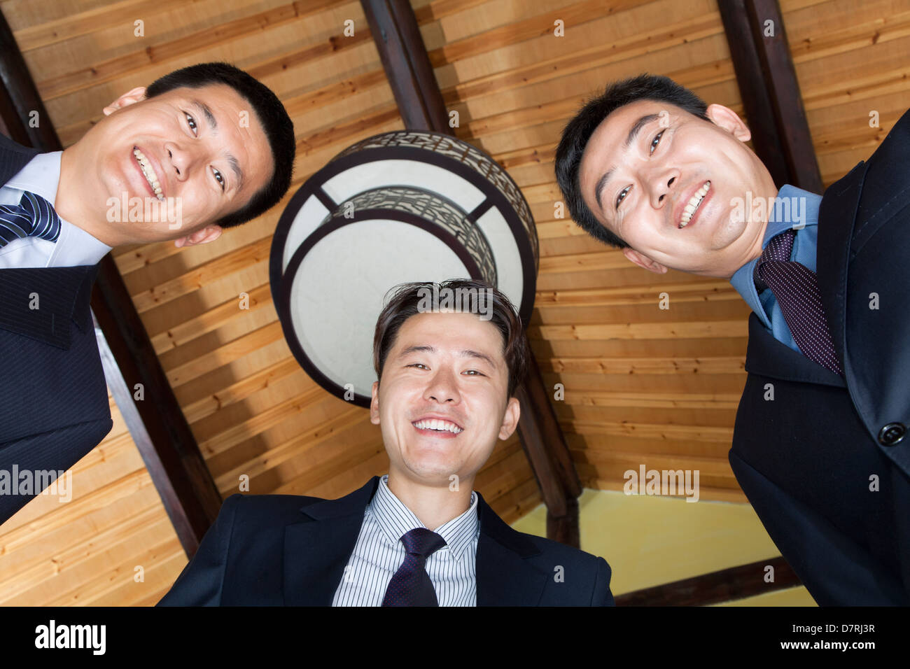 Low Angle Portrait of Three Businessmen Stock Photo - Alamy