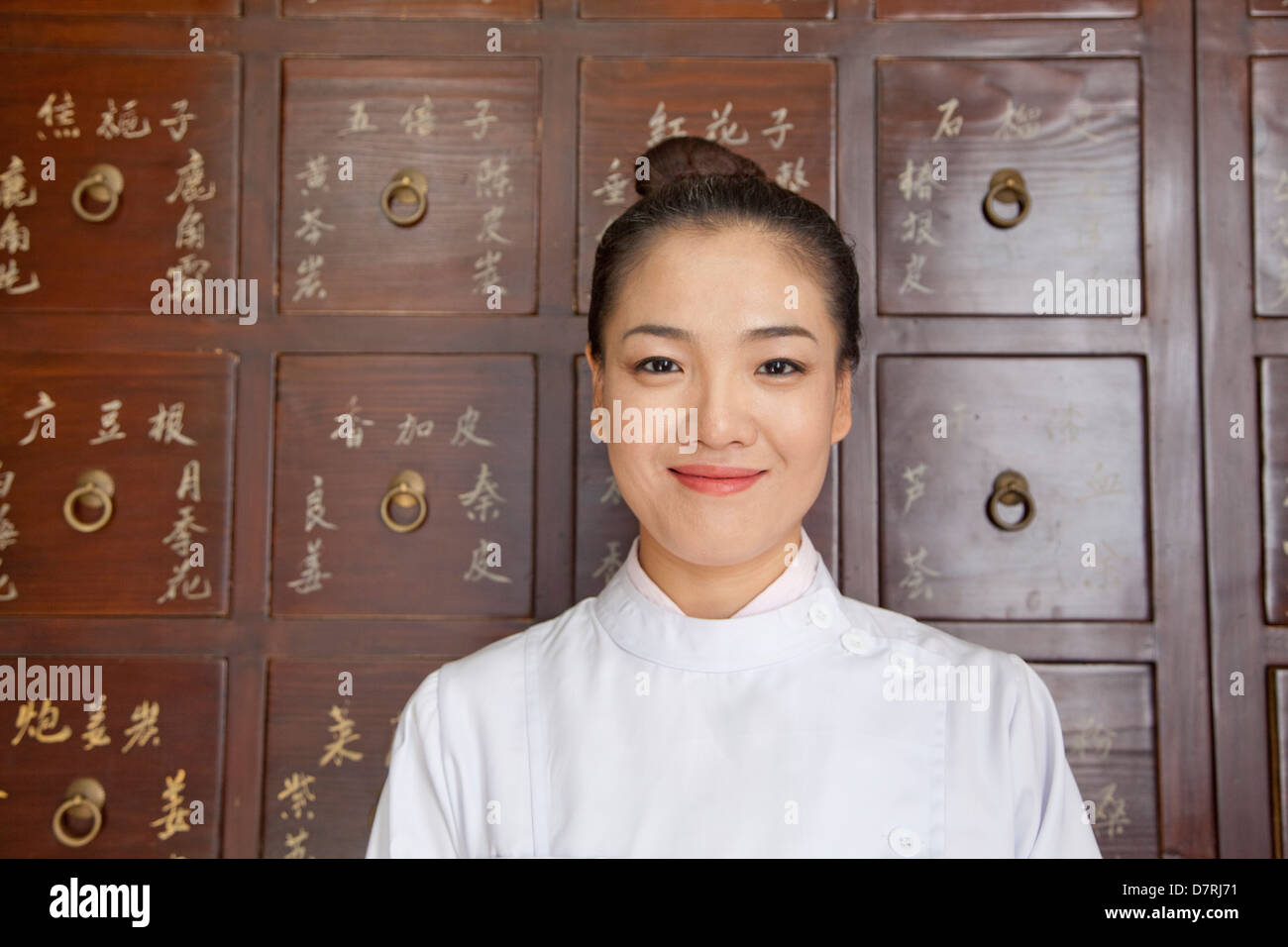 Portrait of Doctor In Front of Traditional Chinese Medicine Cabinet ...
