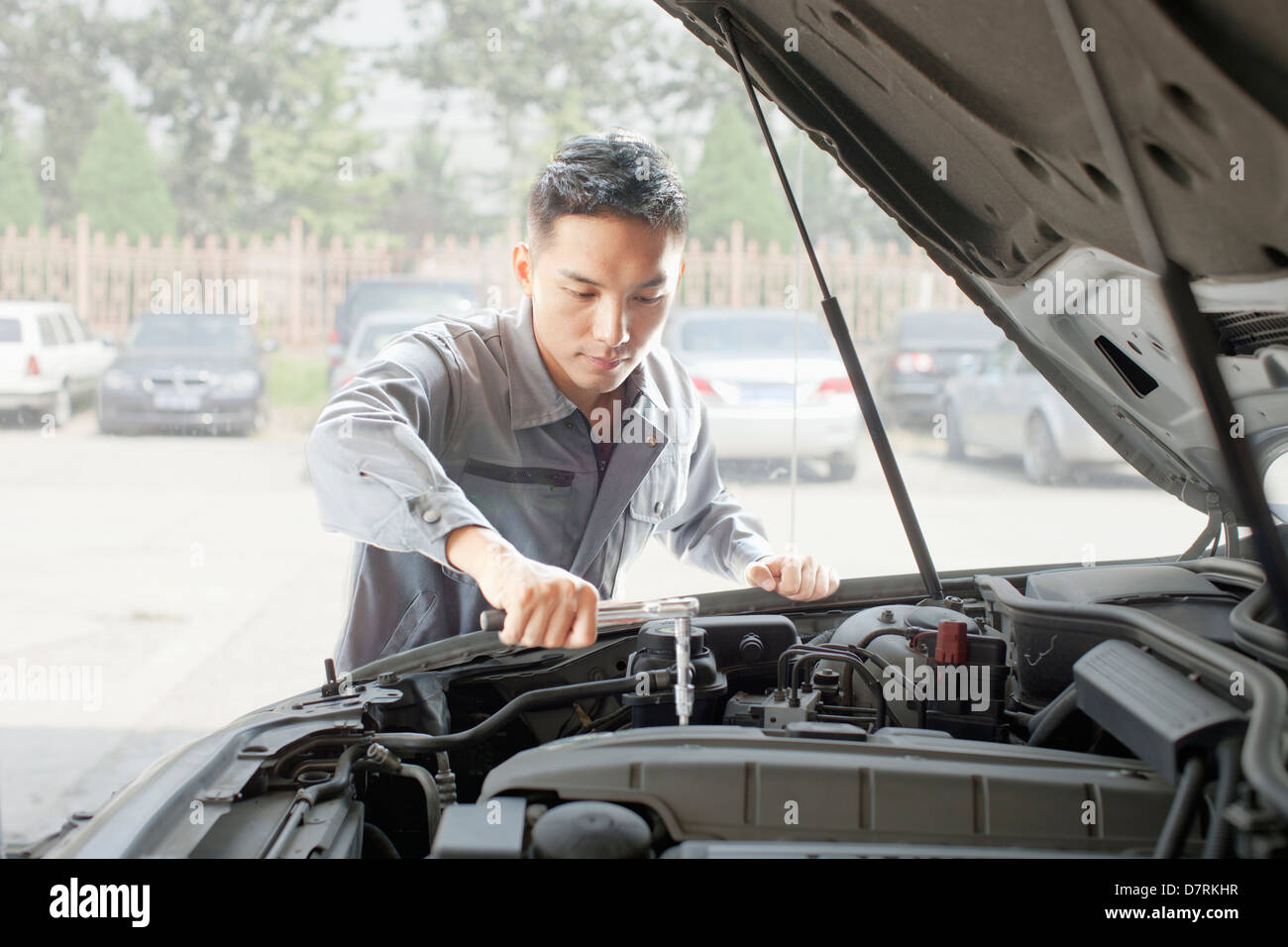Garage Mechanic Working on Engine Stock Photo - Alamy