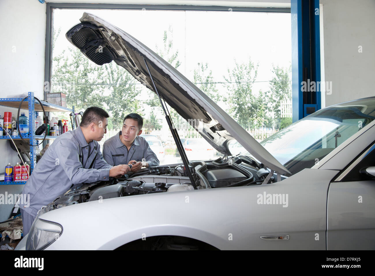 Two Garage Mechanics Working on Engine Stock Photo - Alamy