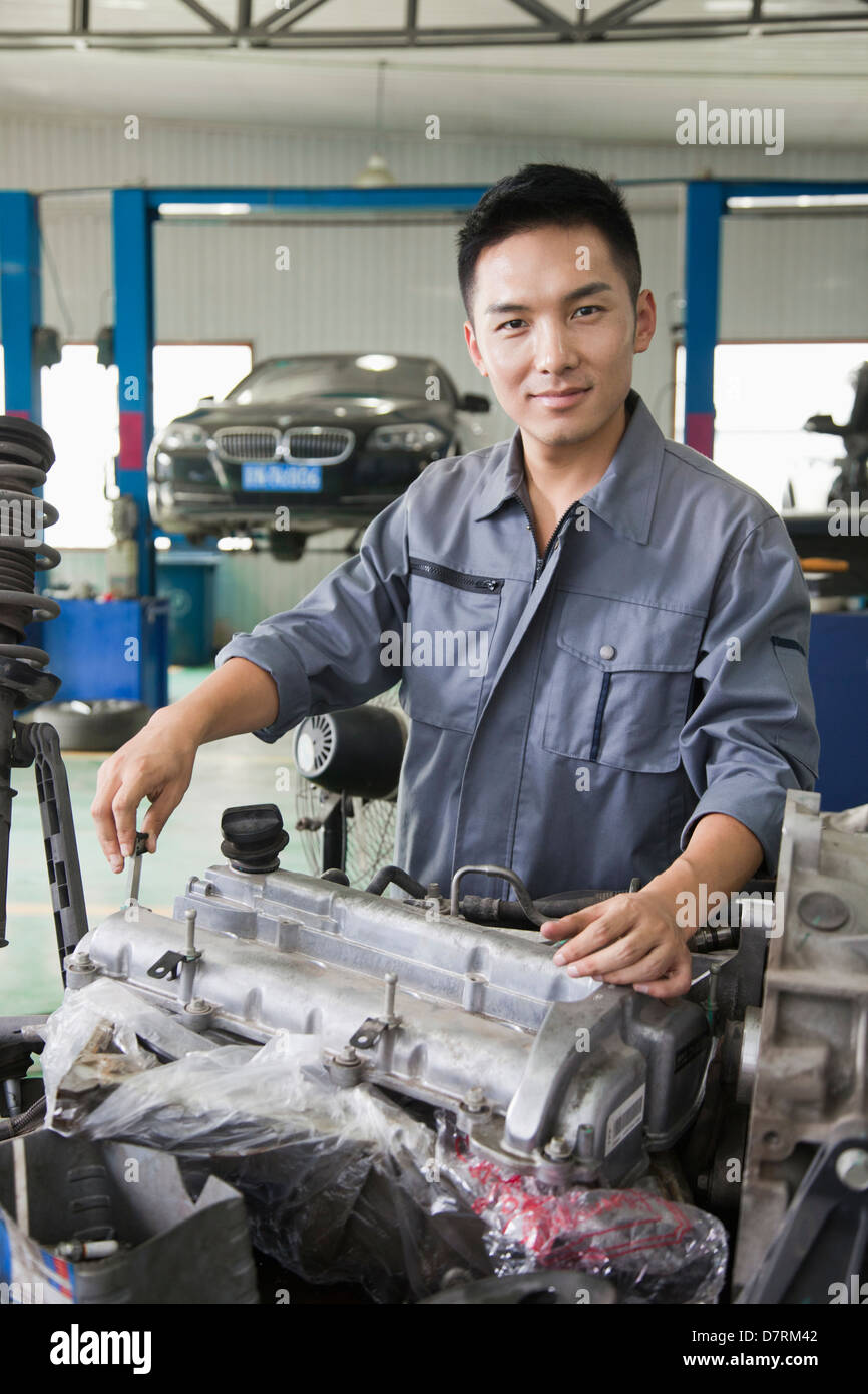 Mechanic Fixing Car Engine Stock Photo - Alamy
