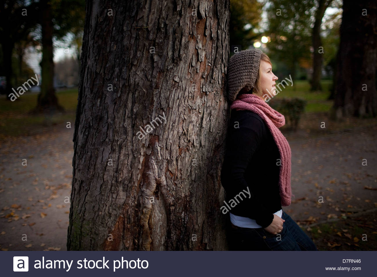 Sad Woman Leaning Against Tree Stock Photos & Sad Woman Leaning Against ...
