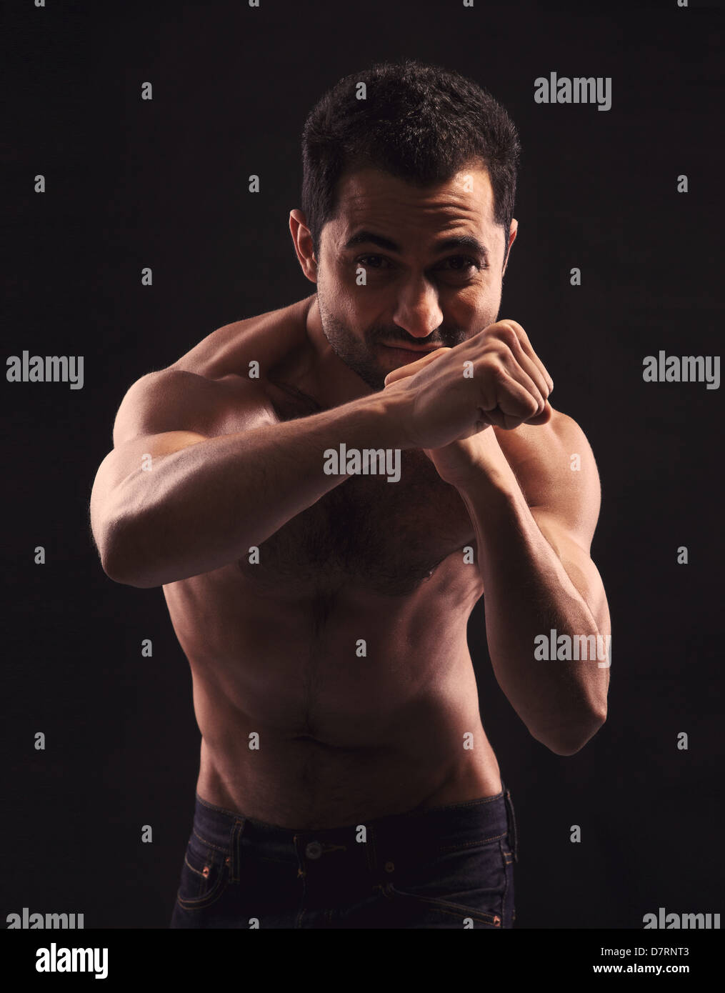 Shirtless aggressive man giving a power punch Stock Photo - Alamy