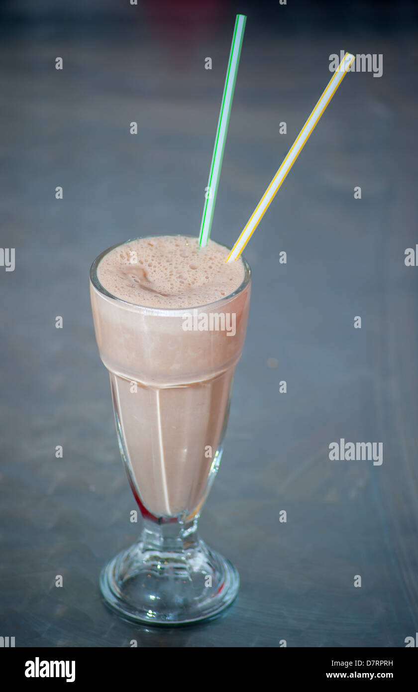 A chocolate milkshake in a tall glass Stock Photo - Alamy
