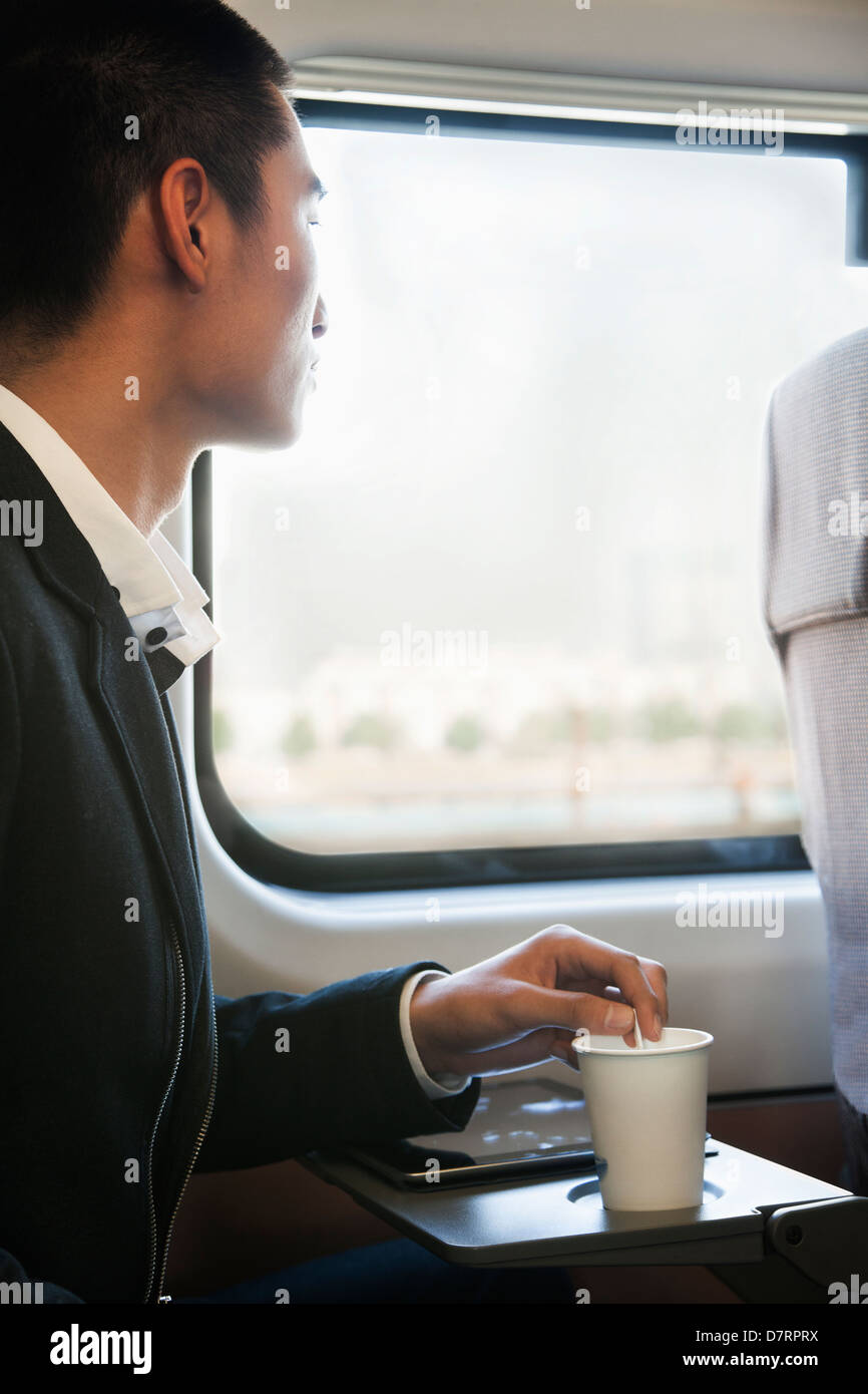 Man Looking Through Train Window While Stirring His Coffee Stock Photo ...