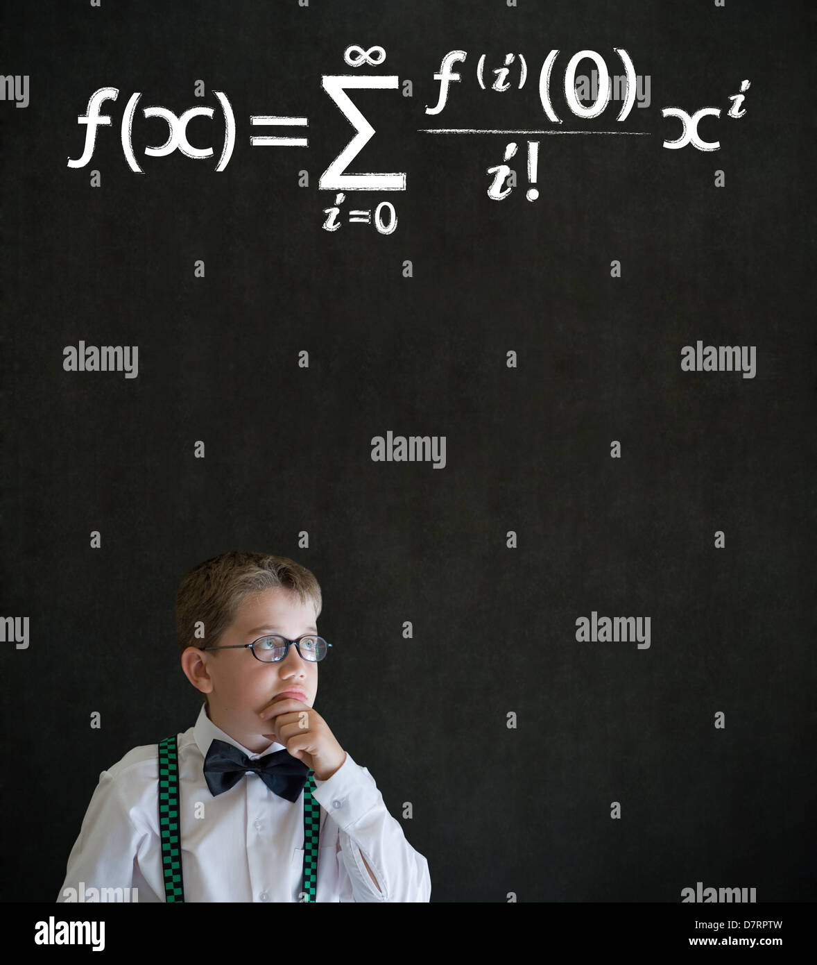 Thinking boy dressed up as business man with maths equation on ...