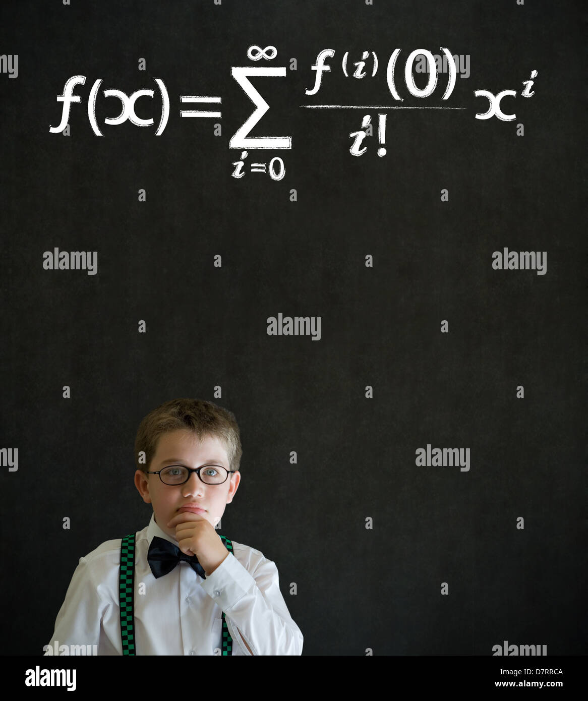 Thinking boy dressed up as business man with maths equation on ...