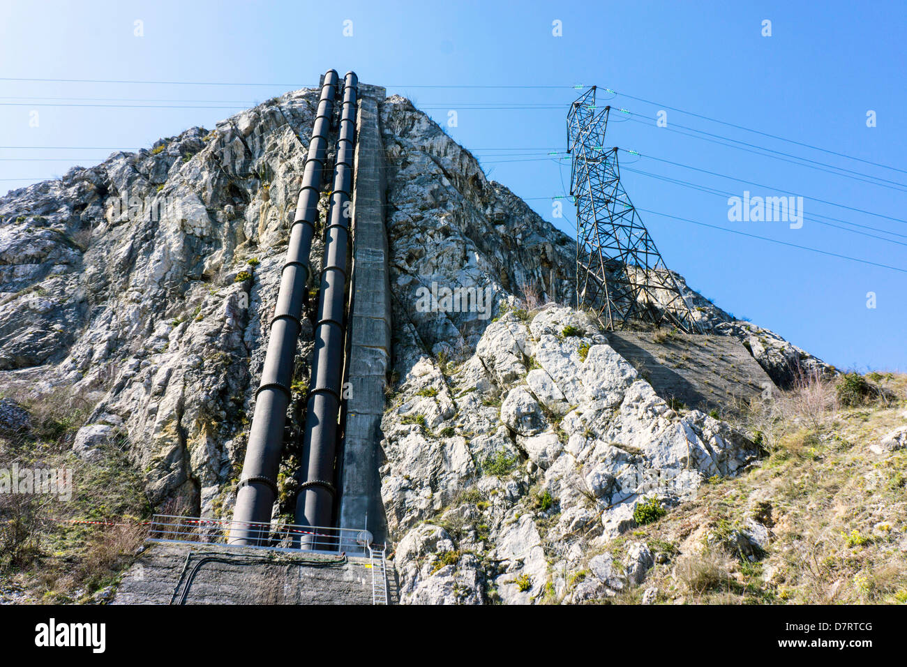 Huge pipes carry water to hydroelectric power-plant, pylon, industrial ...