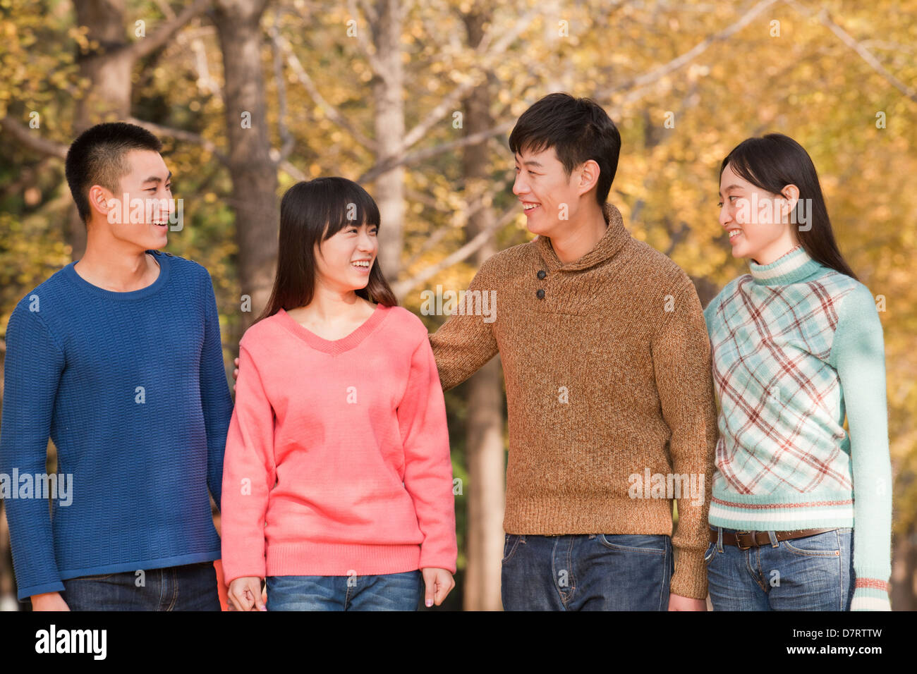 Friends walking together in park Stock Photo - Alamy