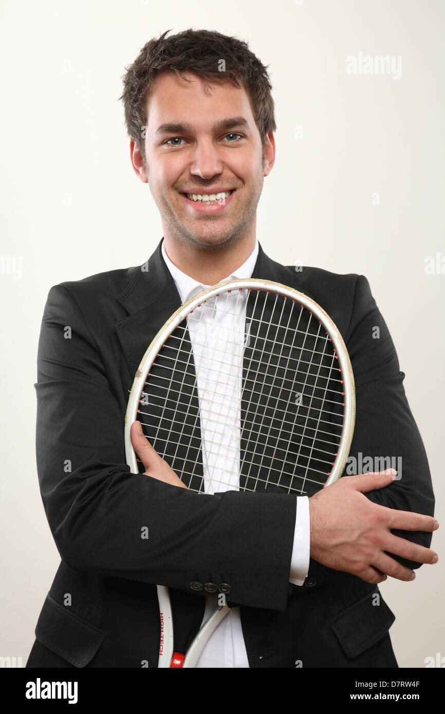 young business man with tennis racket Stock Photo - Alamy