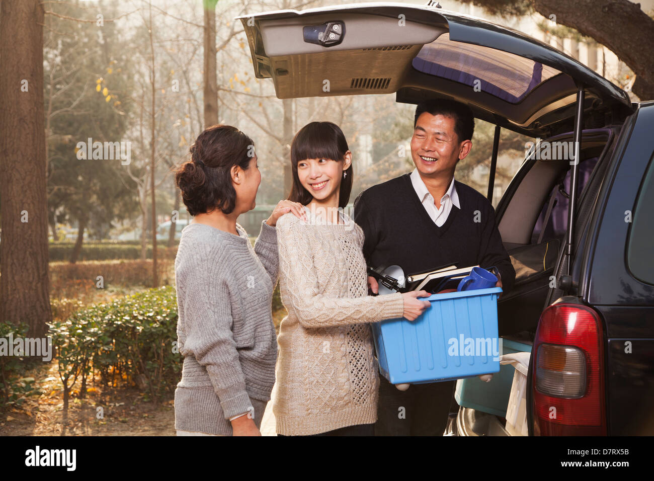 Family unpacking minivan for college, Beijing Stock Photo - Alamy