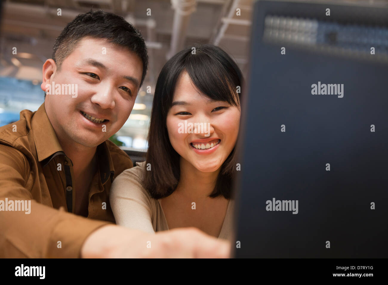 Two Business People Looking at Computer in the Office Stock Photo - Alamy