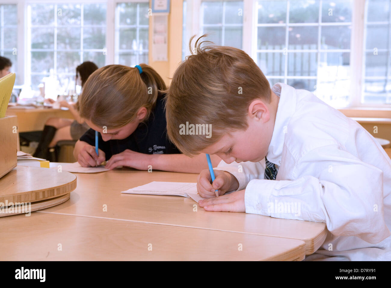 young pupils complete exercise in classroom Stock Photo - Alamy