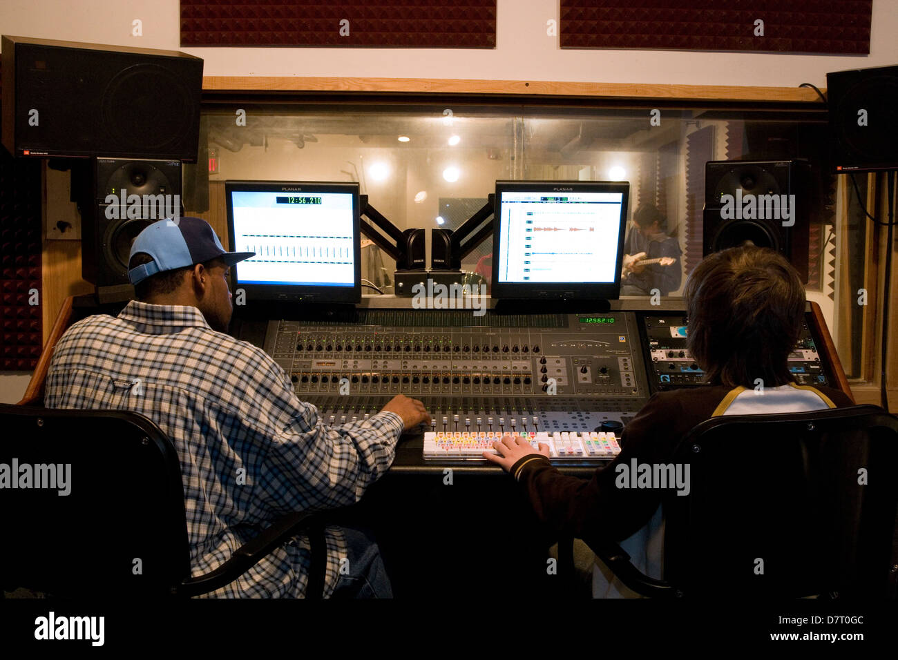 Studio technicians at recording mixing-desk Stock Photo - Alamy