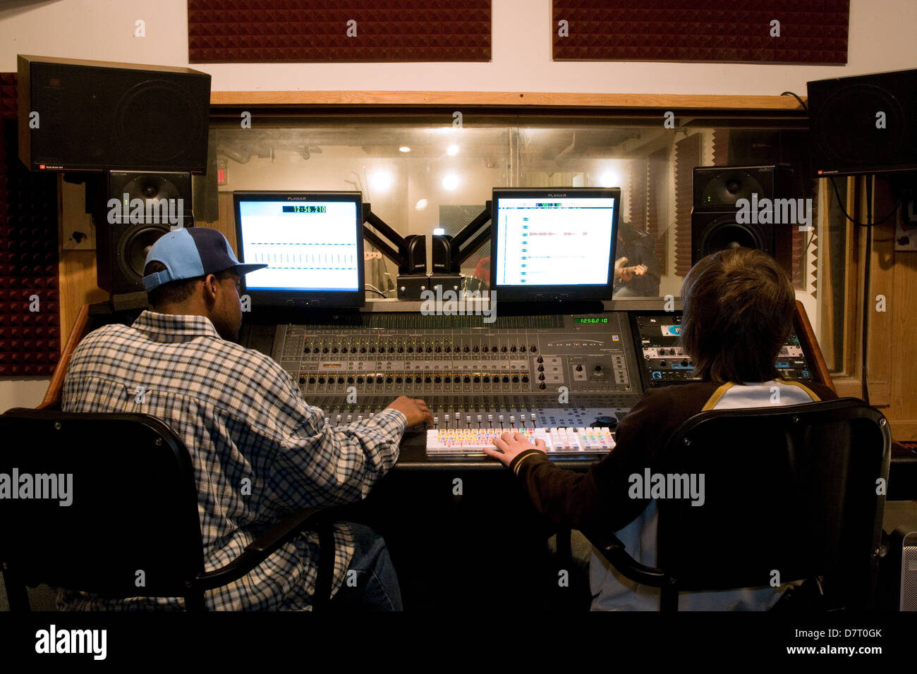 Studio technicians at recording mixing-desk Stock Photo - Alamy