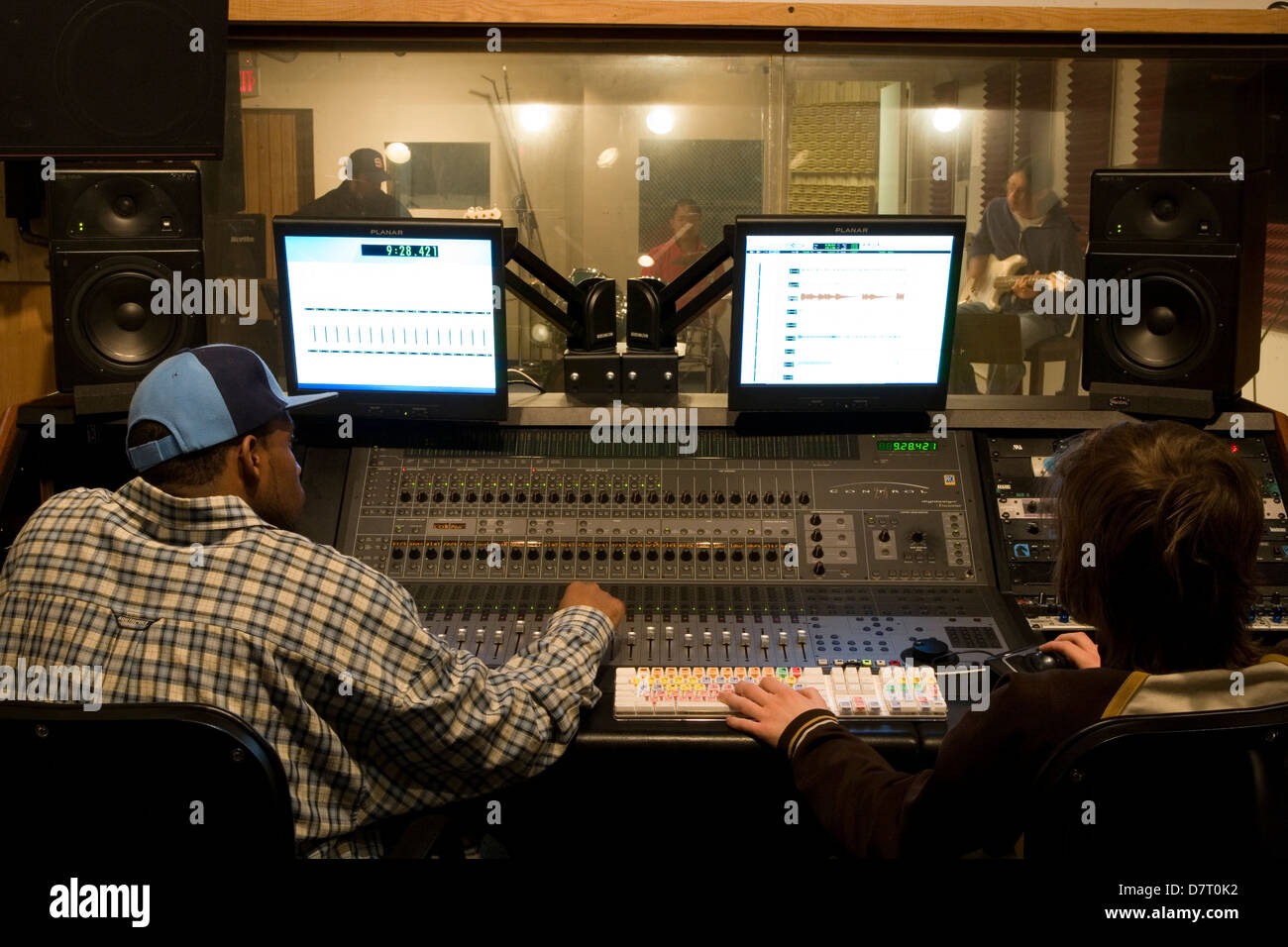 Studio technicians at recording mixing-desk Stock Photo - Alamy