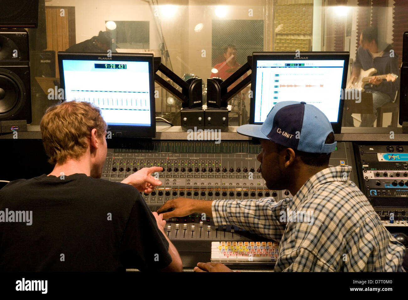 Studio technicians at recording mixing-desk Stock Photo - Alamy