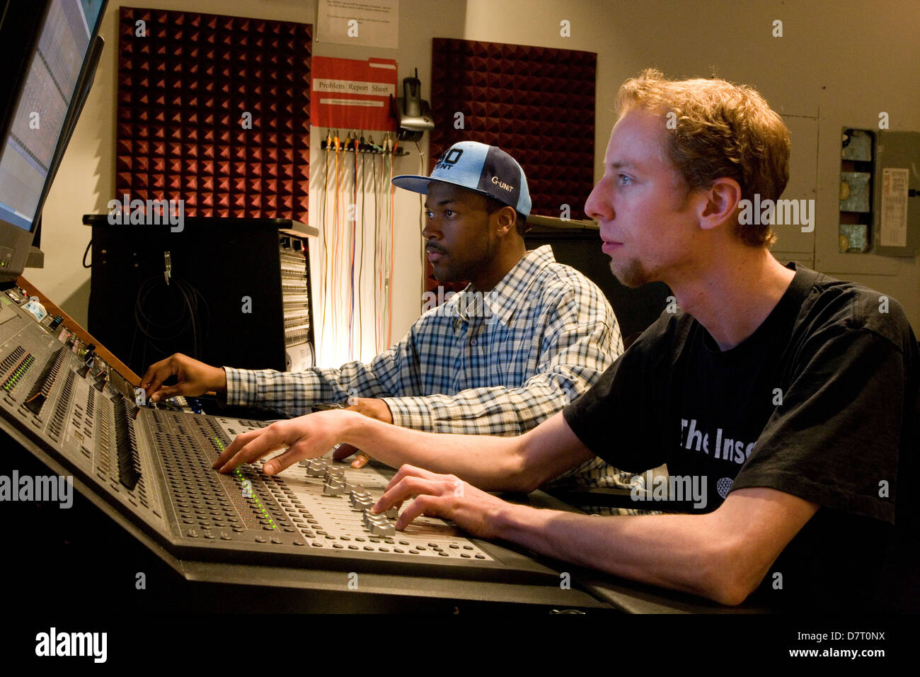 Studio technicians at recording mixing-desk Stock Photo - Alamy