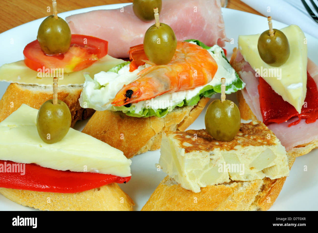Spanish tapas selection including tortilla, cheese, prawn and ham, all ...