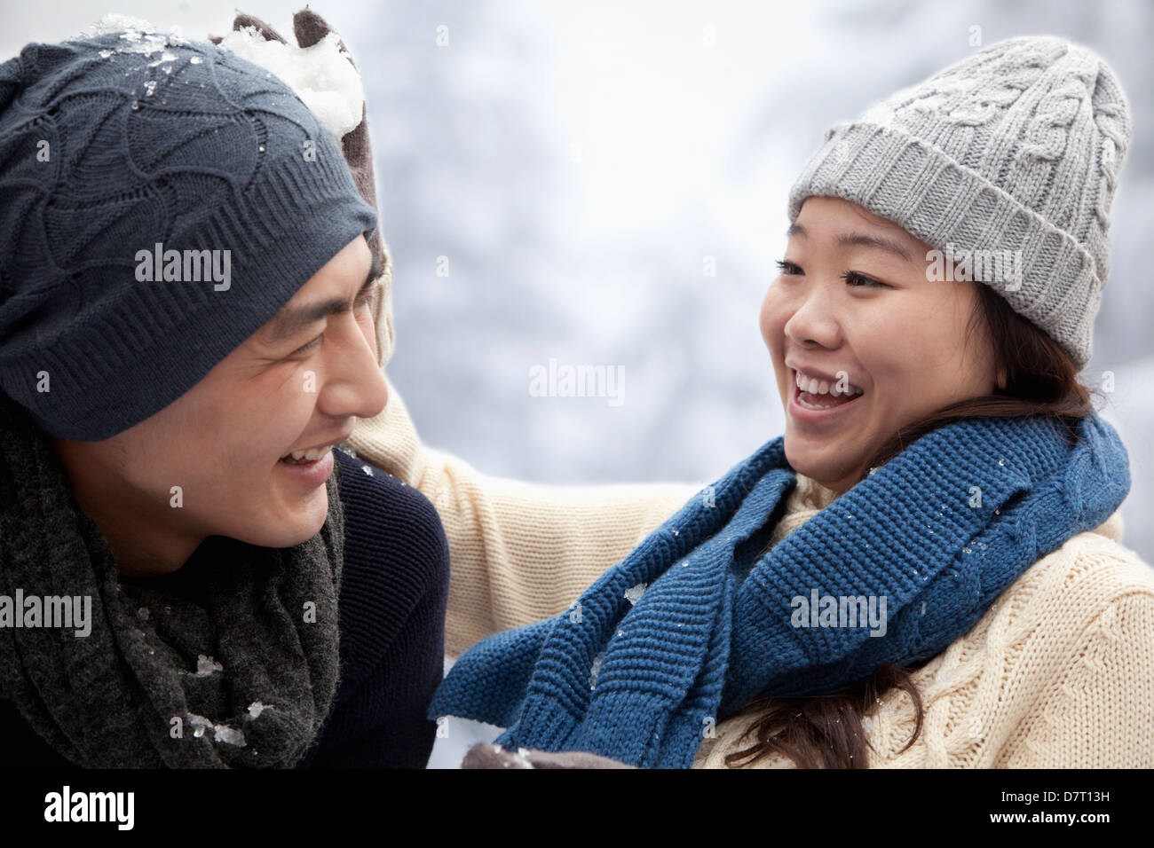 Young Couple Having a Snowball Fight Stock Photo - Alamy