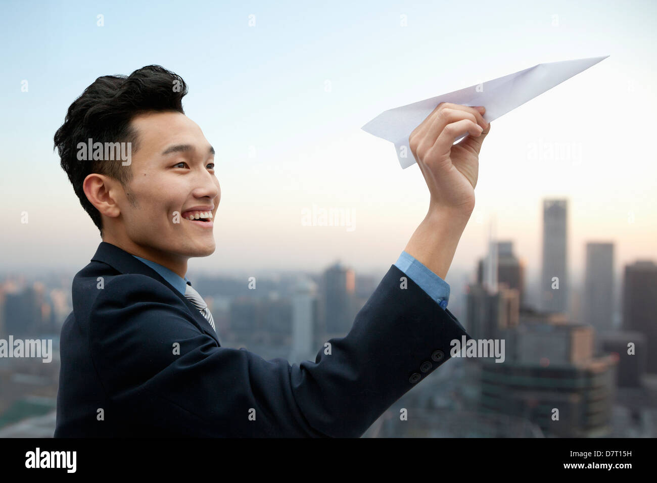 Businessman Flying Paper Airplane Stock Photo - Alamy