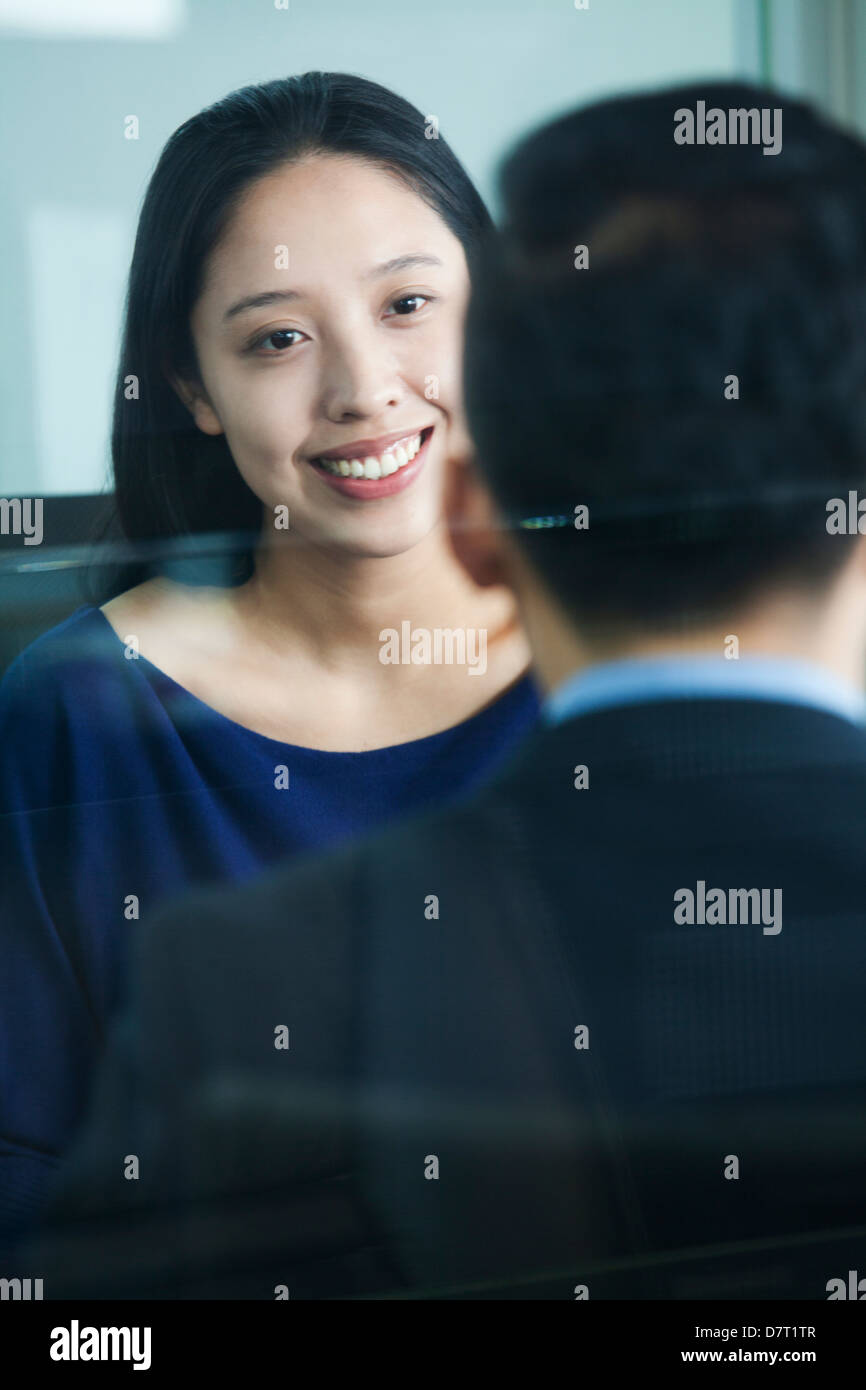Two co-workers talking in office Stock Photo - Alamy