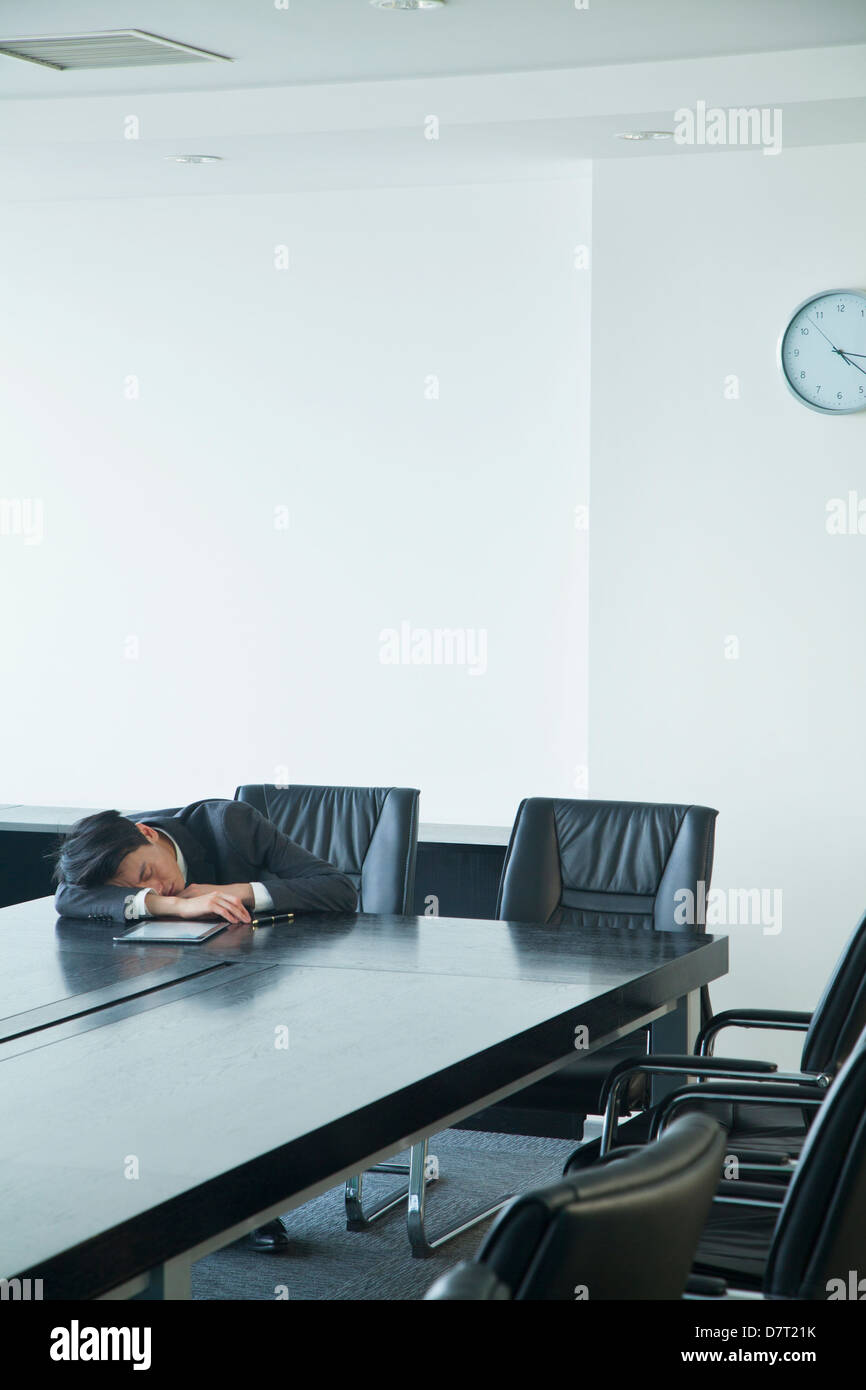 Businessman sleeping in office room Stock Photo - Alamy