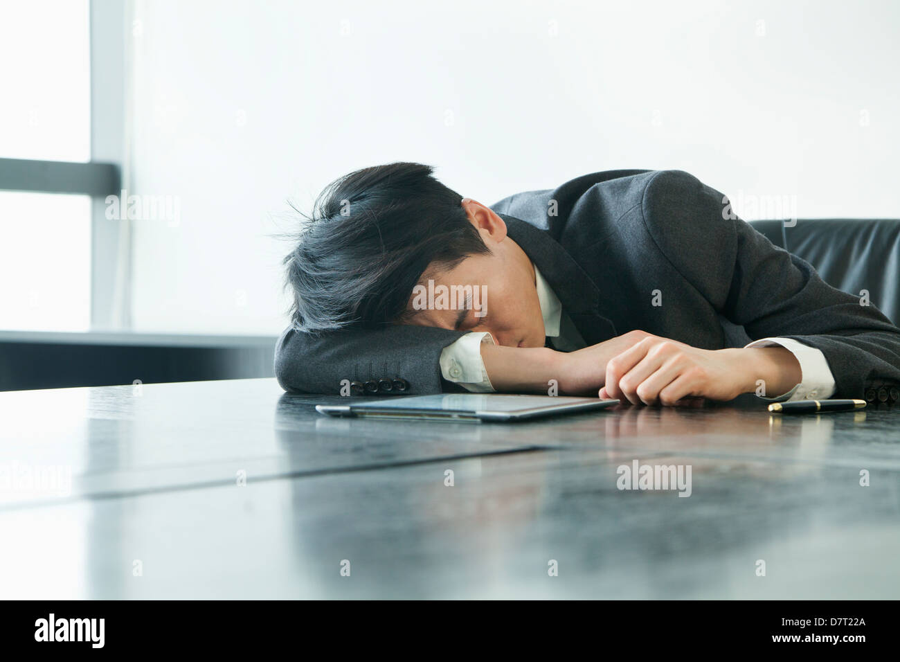 Businessman sleeping in office room Stock Photo - Alamy