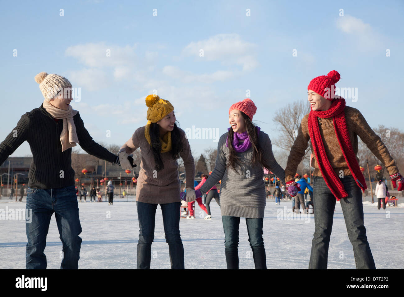Friends on ice rink Stock Photo - Alamy