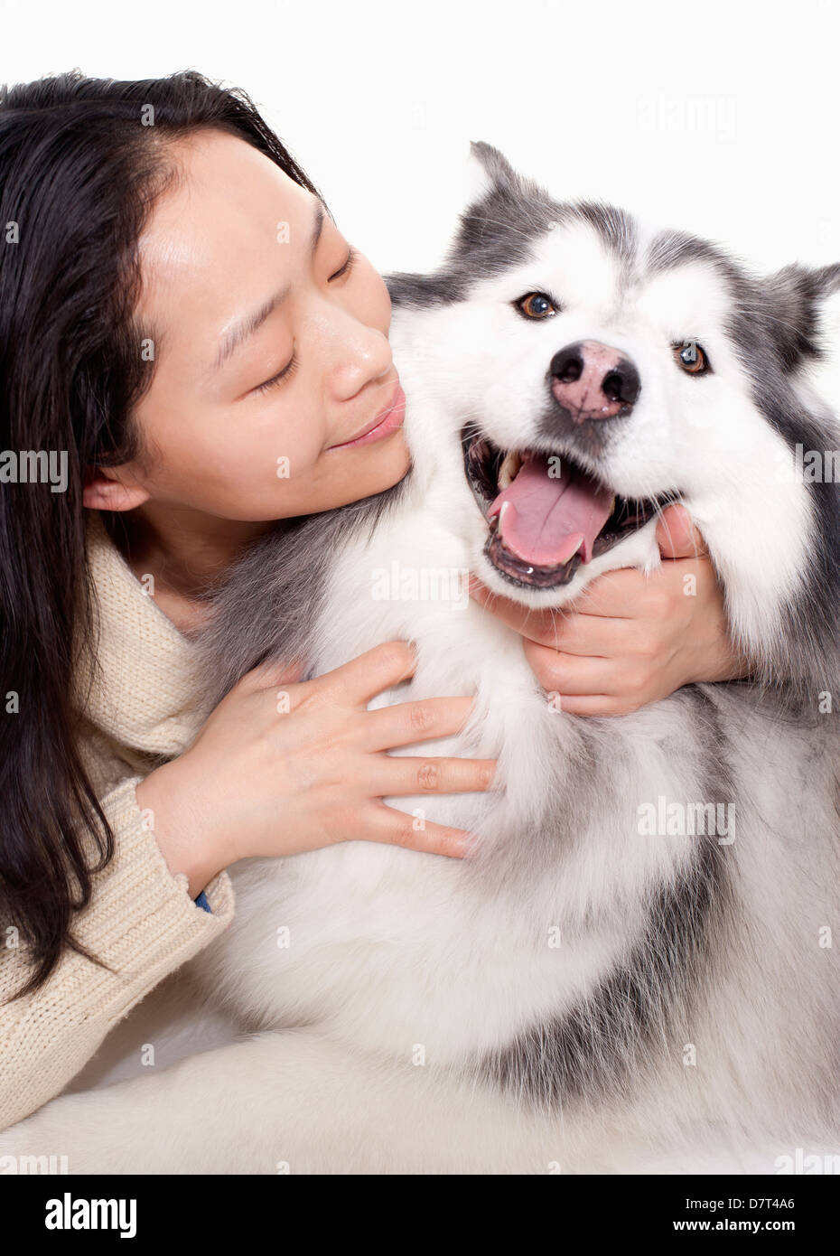 Portrait of woman embracing her dog, studio shot Stock Photo - Alamy