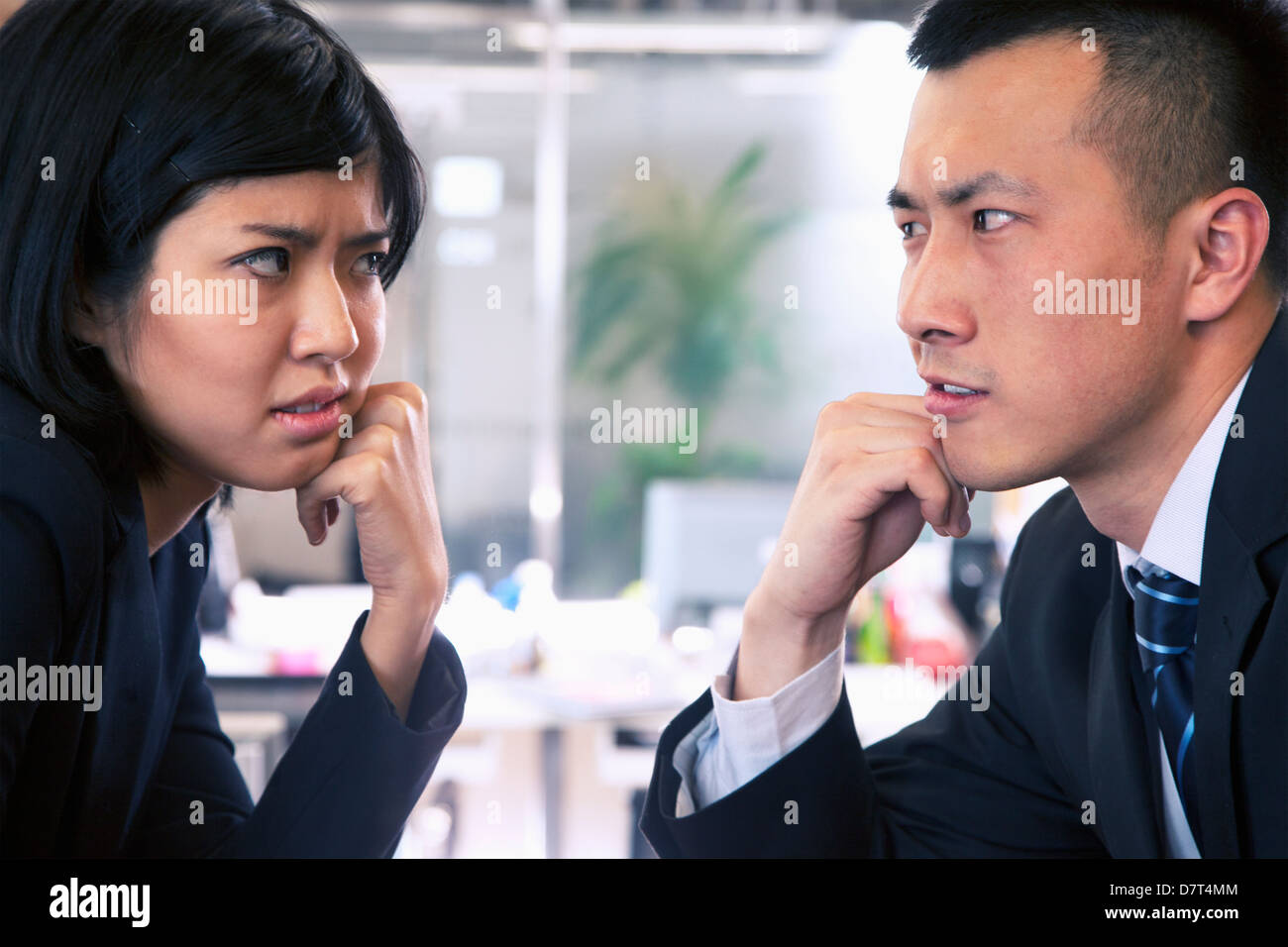 Two Business people staring at each other across a table Stock Photo ...