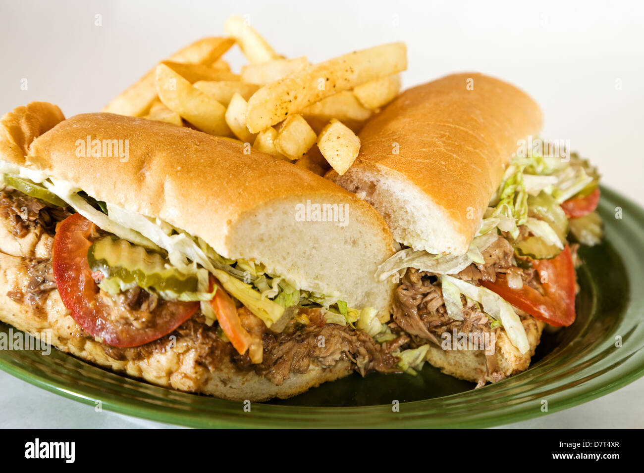 Roast beef po'boy with fries Stock Photo - Alamy
