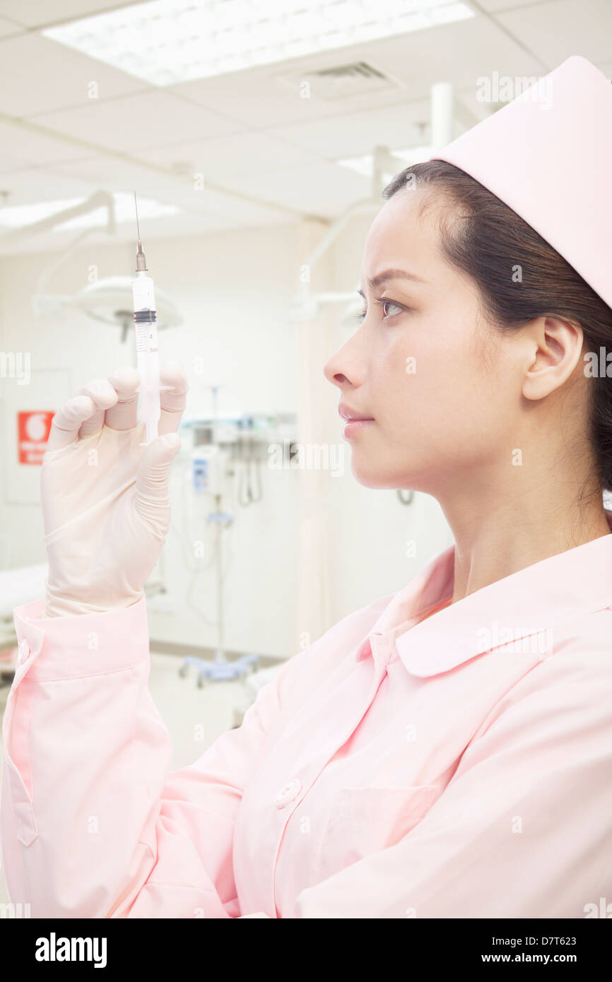 Portrait of Nurse Holding A Syringe, Profile Stock Photo - Alamy