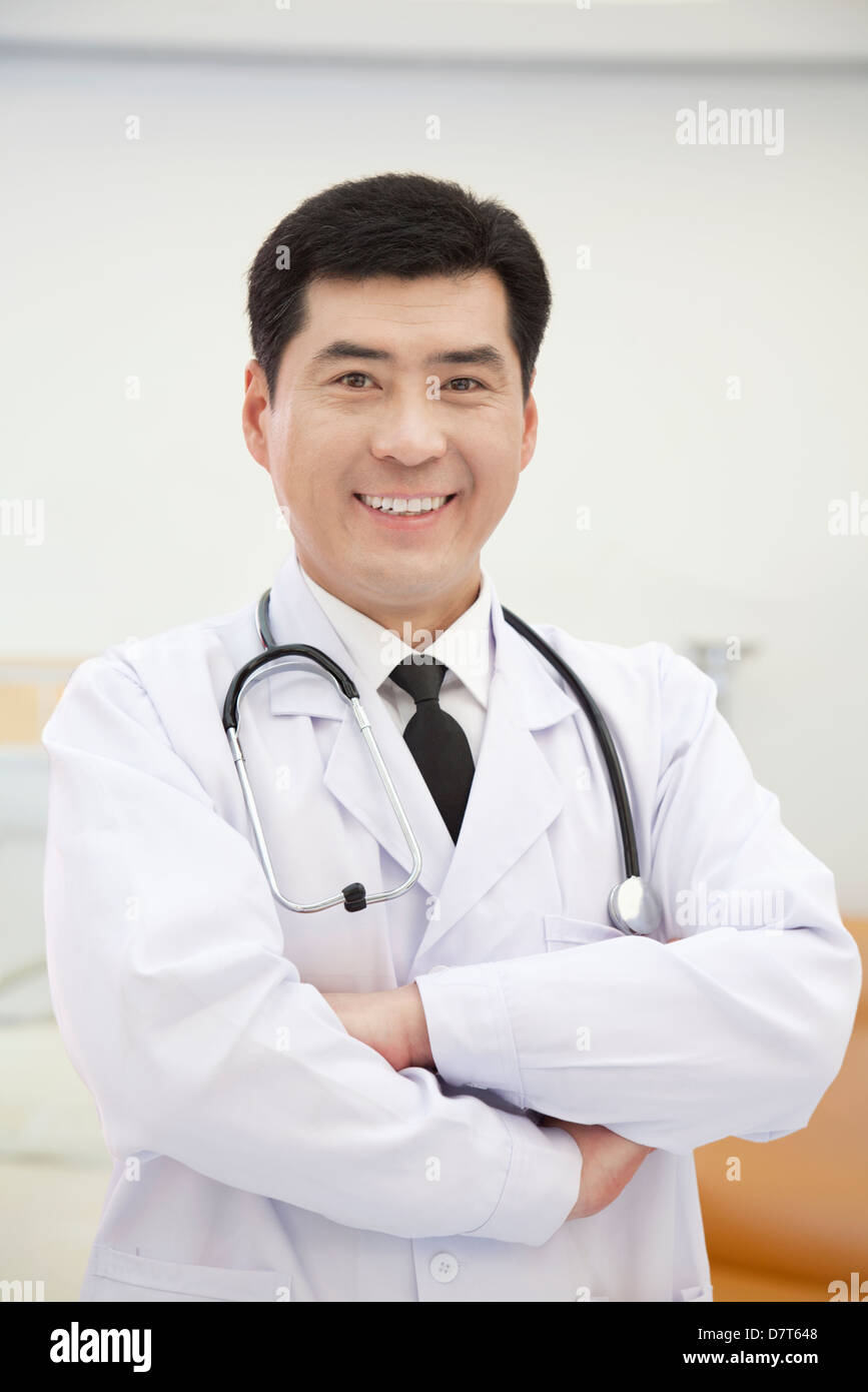 Portrait of Doctor Standing With Arms Crossed Stock Photo - Alamy