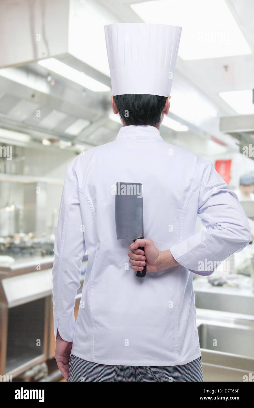 Rear View of Chef with Knife Behind his Back Stock Photo - Alamy