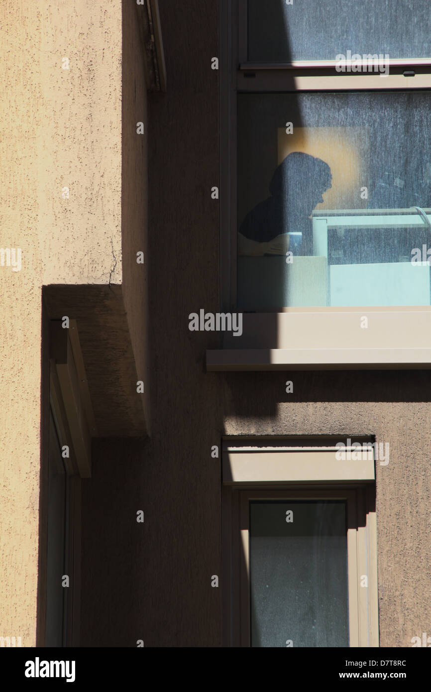 office worker in window in rome italy Stock Photo - Alamy