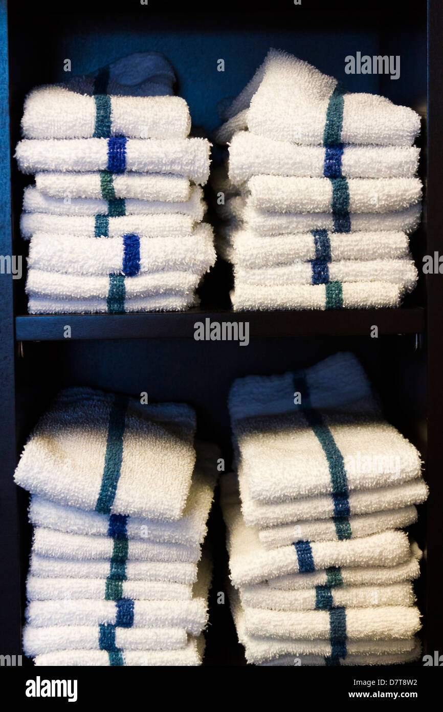 Stack of white towels in small gym Stock Photo - Alamy