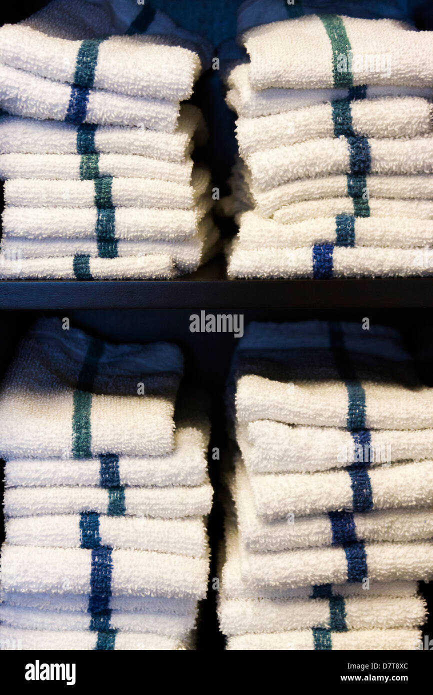 Stack of white towels in small gym Stock Photo - Alamy