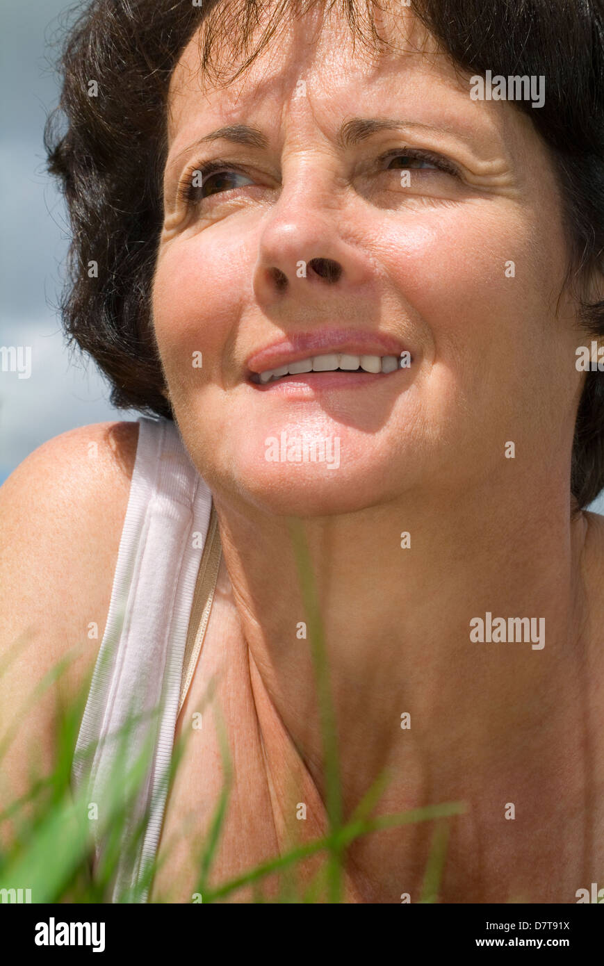 senior, woman, happy retirement, relax, portrait, grass, garden, park ...