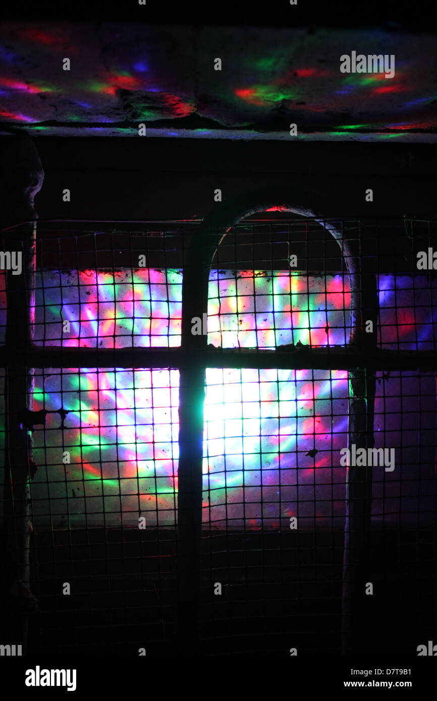bright colourful lights seen through window bars at night Stock Photo ...