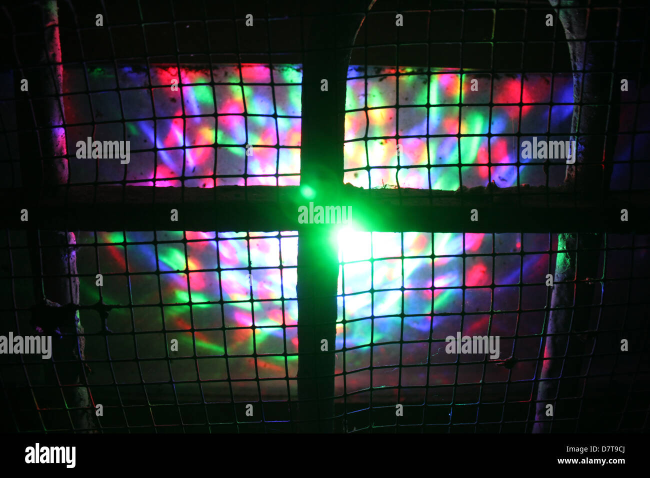 bright colourful lights seen through window bars at night Stock Photo ...