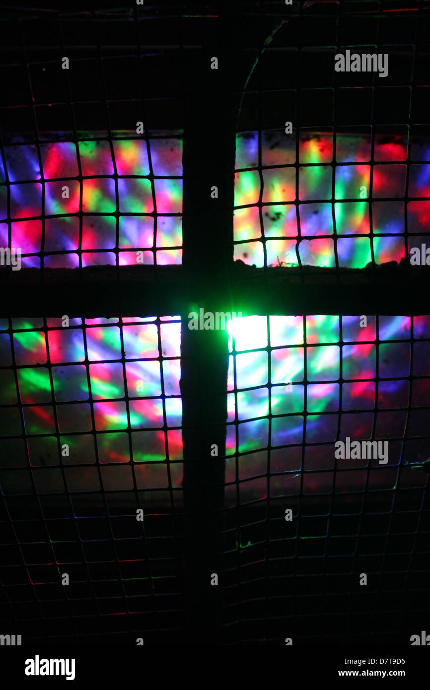 bright colourful lights seen through window bars at night Stock Photo ...