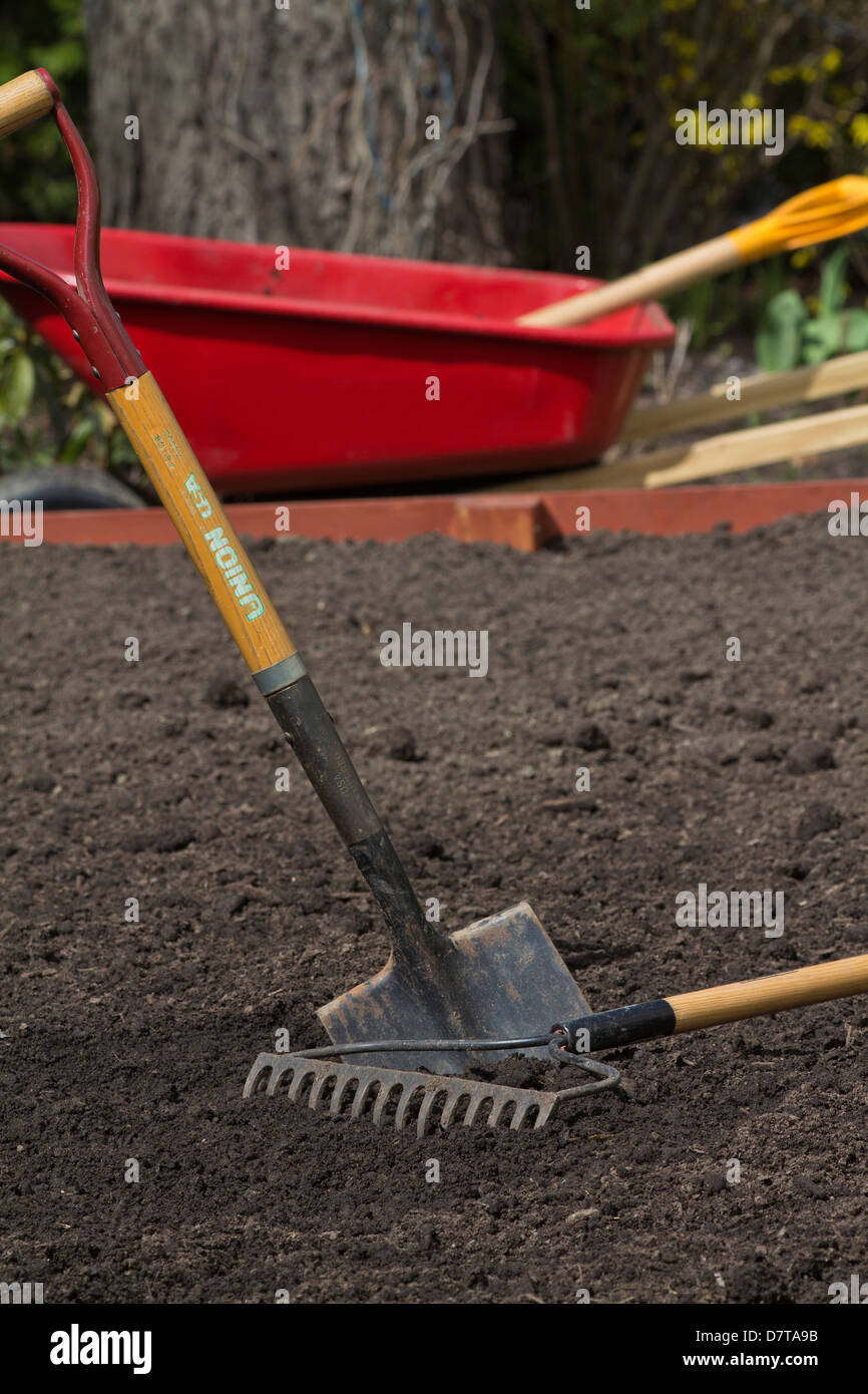 A spade in soil Spring work in the garden.Raised bed with spade in soil ...