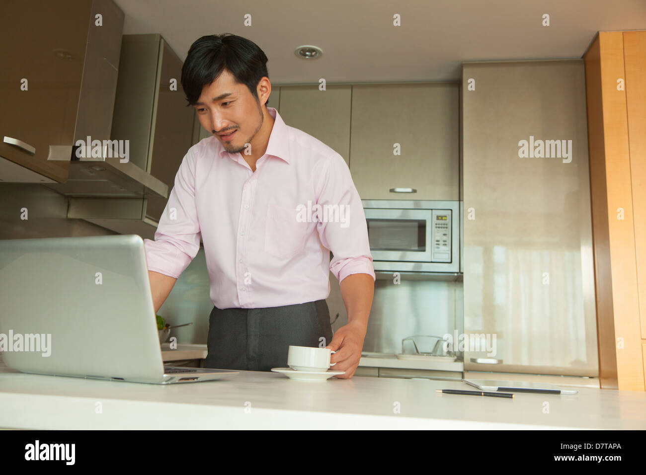 Businessman in front of his computer drinking coffee at home Stock ...
