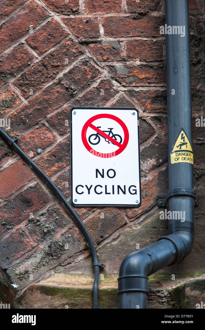 No cycling sign, and danger of death sign on drainpipe Stock Photo - Alamy
